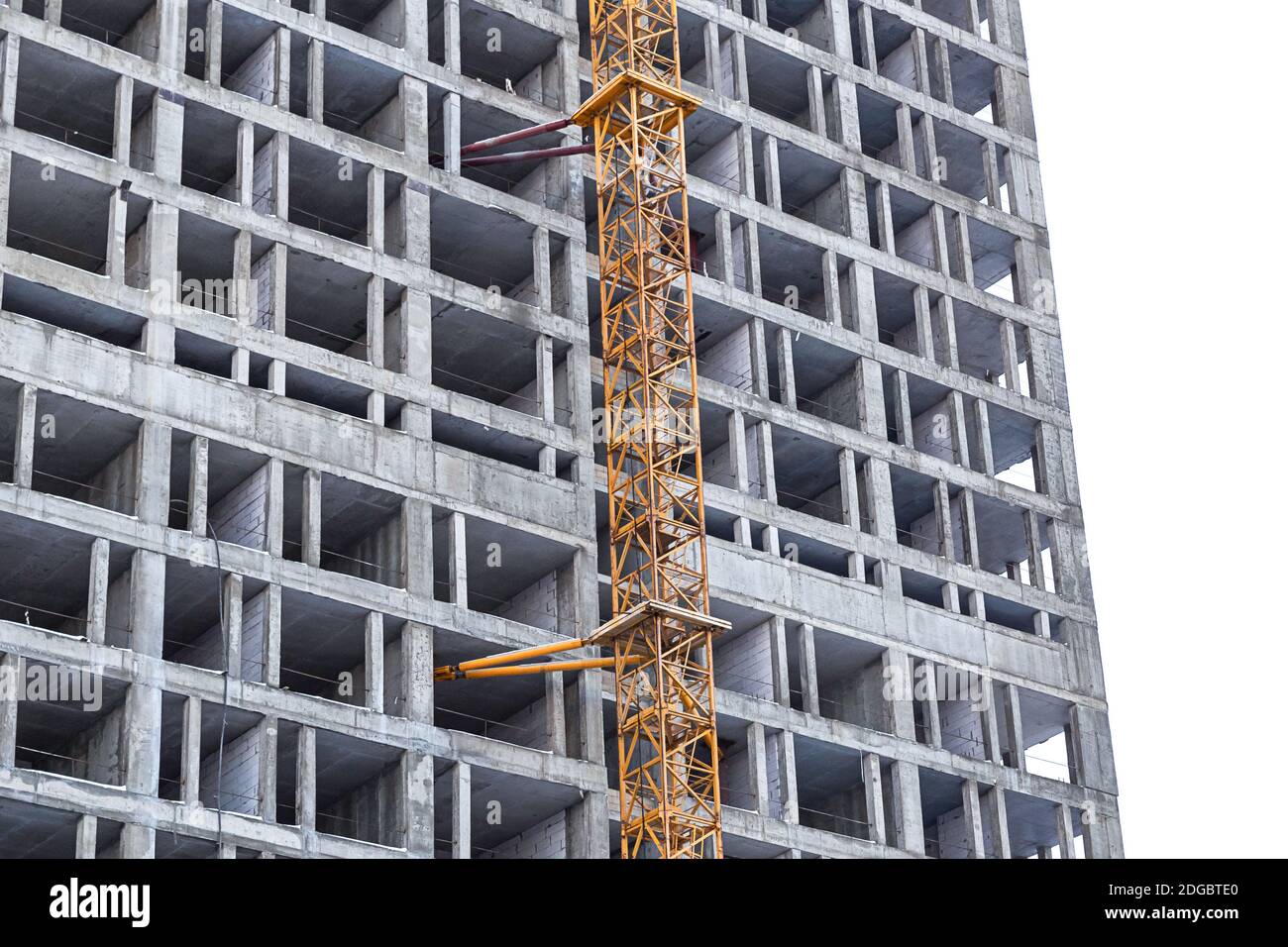 High-rise office building under construction cement near the iron crane ...