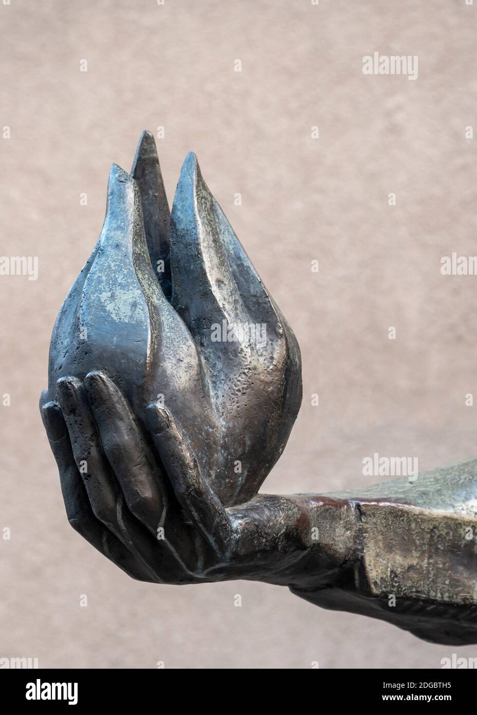 Woman's hand holding flame bronze statue Stock Photo - Alamy