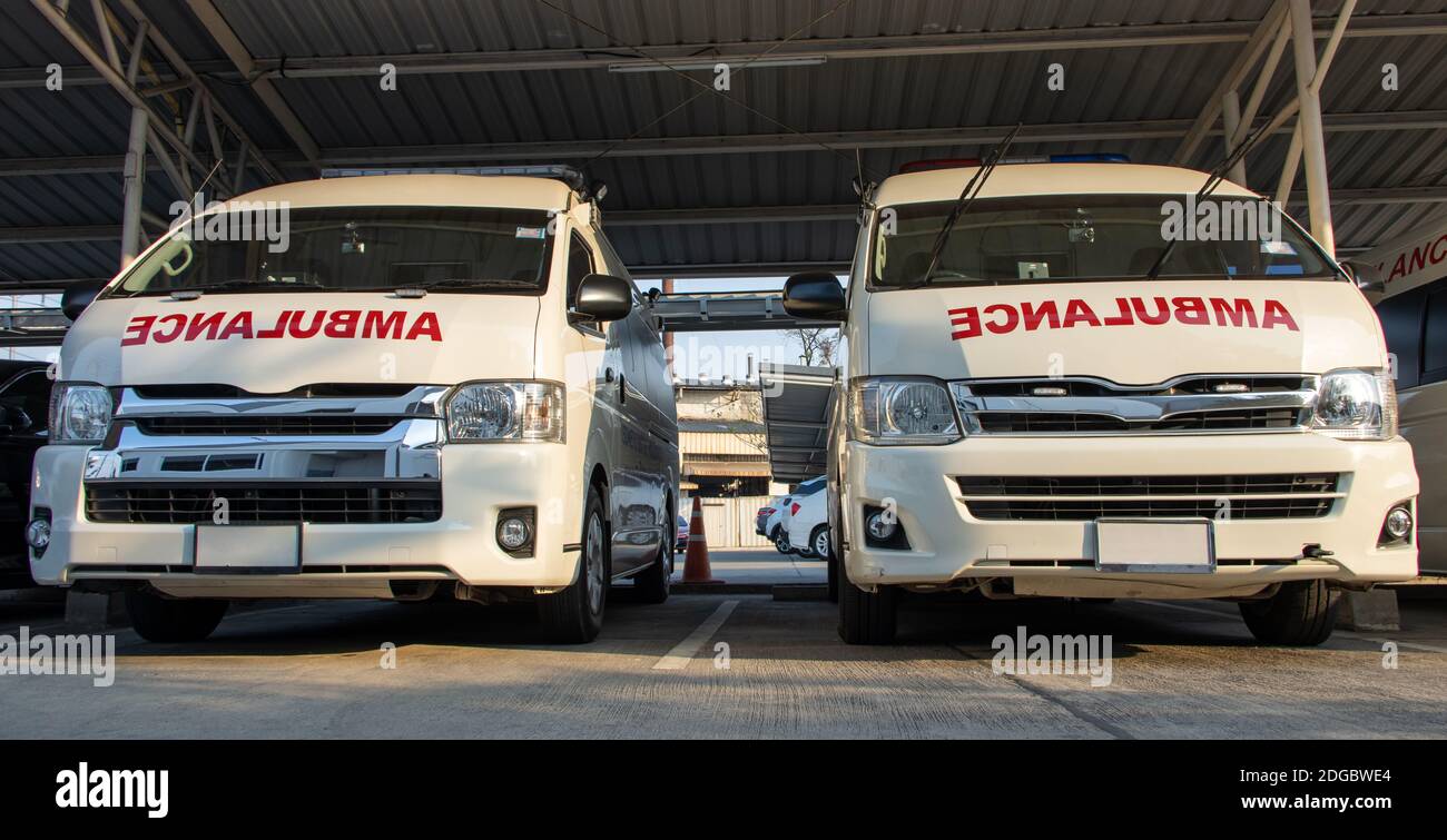 Front of ambulances standing in parking lot of hospital. A row cars of ...