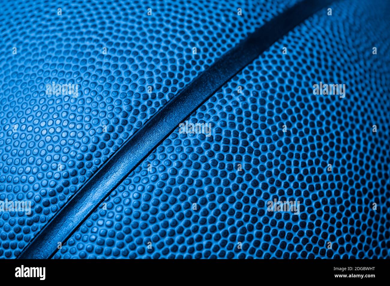 Closeup detail of basketball ball texture background. Blue color filter ...