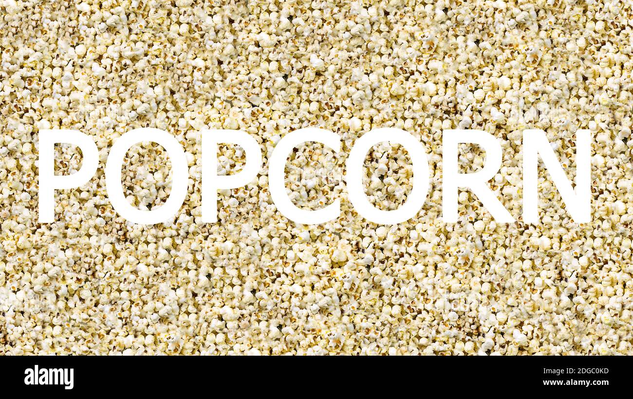 White inscription base word popcorn on a background of airy white corn ...
