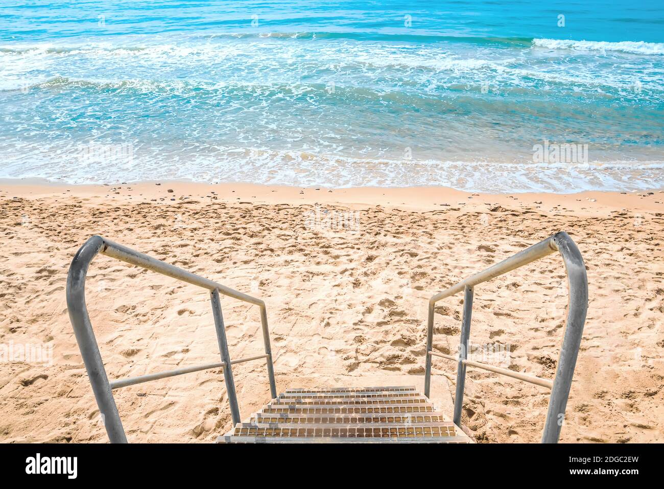 View of steps with a handrail leaders on the clean sandy beach Stock ...