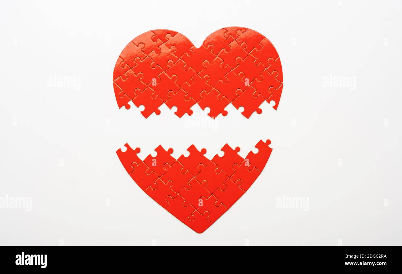 Top view of unconnected parts of heart shaped puzzle on white ...
