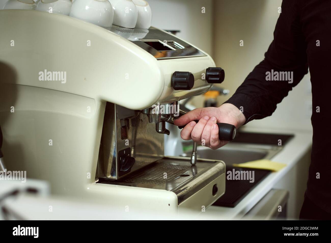 Male barista holding tamper hi-res stock photography and images - Alamy