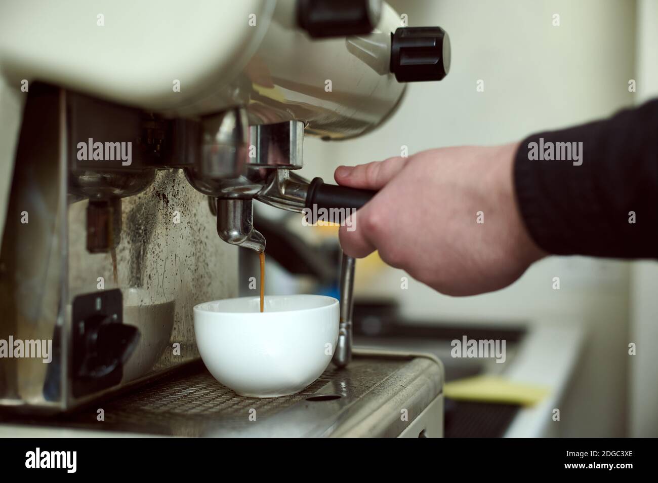 Close-up of barista's hands preparing espresso in the professional ...