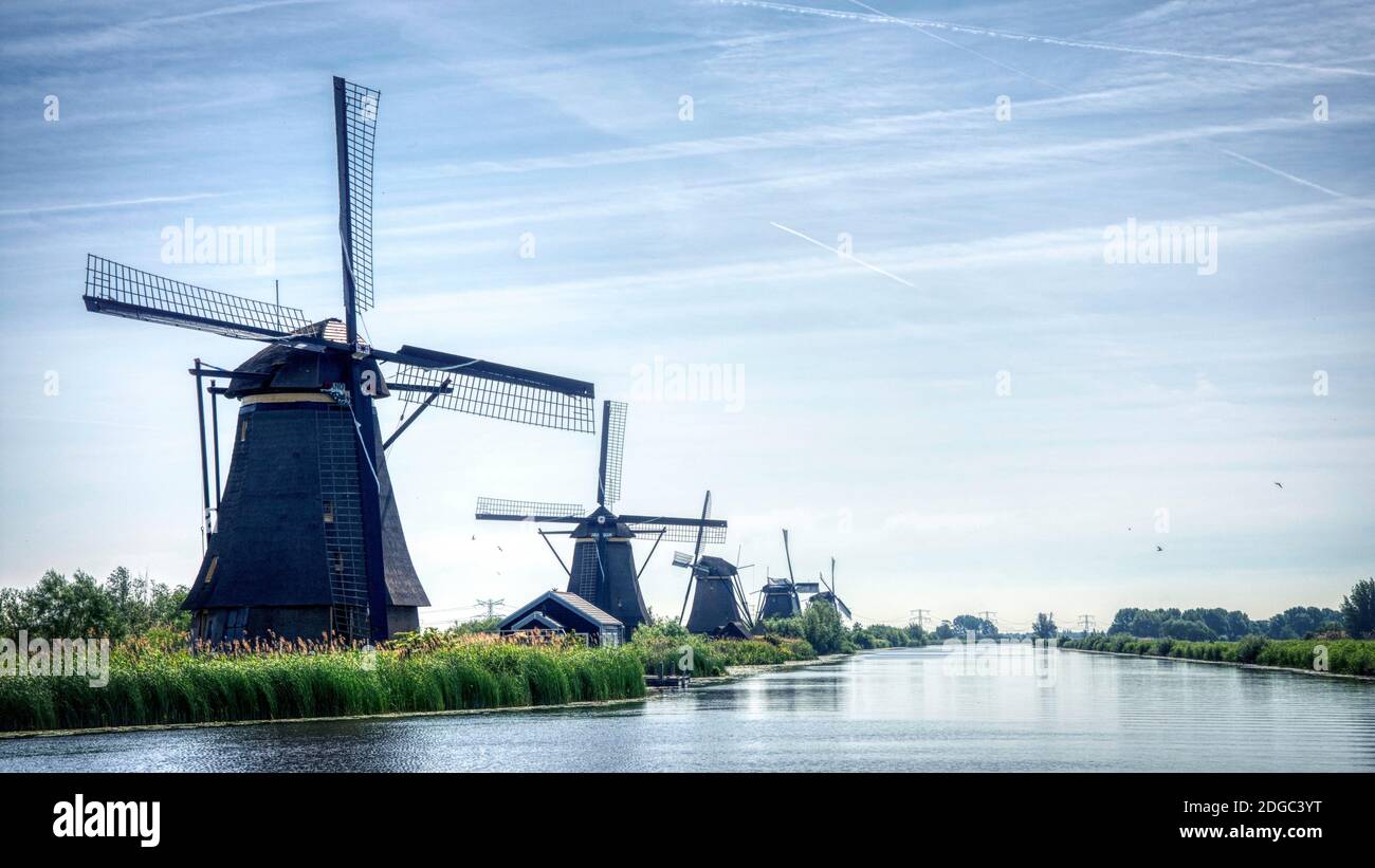 traditional dutch windmills at riverside, landscape picture in the ...