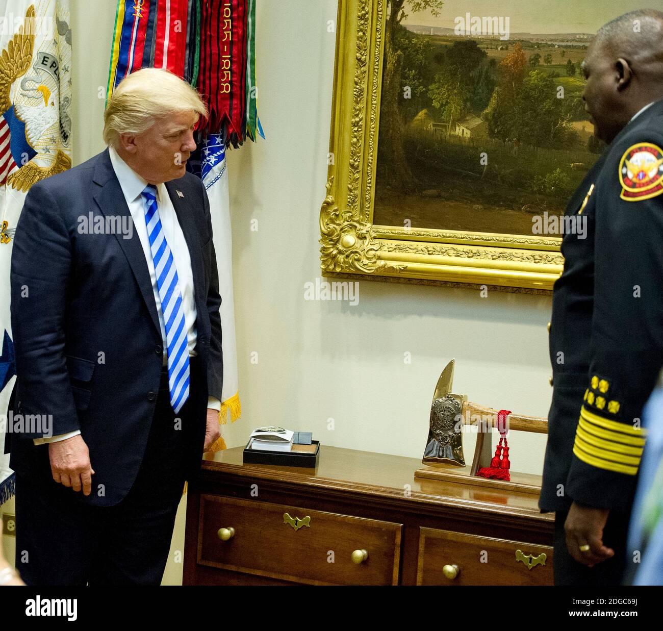 United States President Donald J. Trump is presented with a fire axe by ...