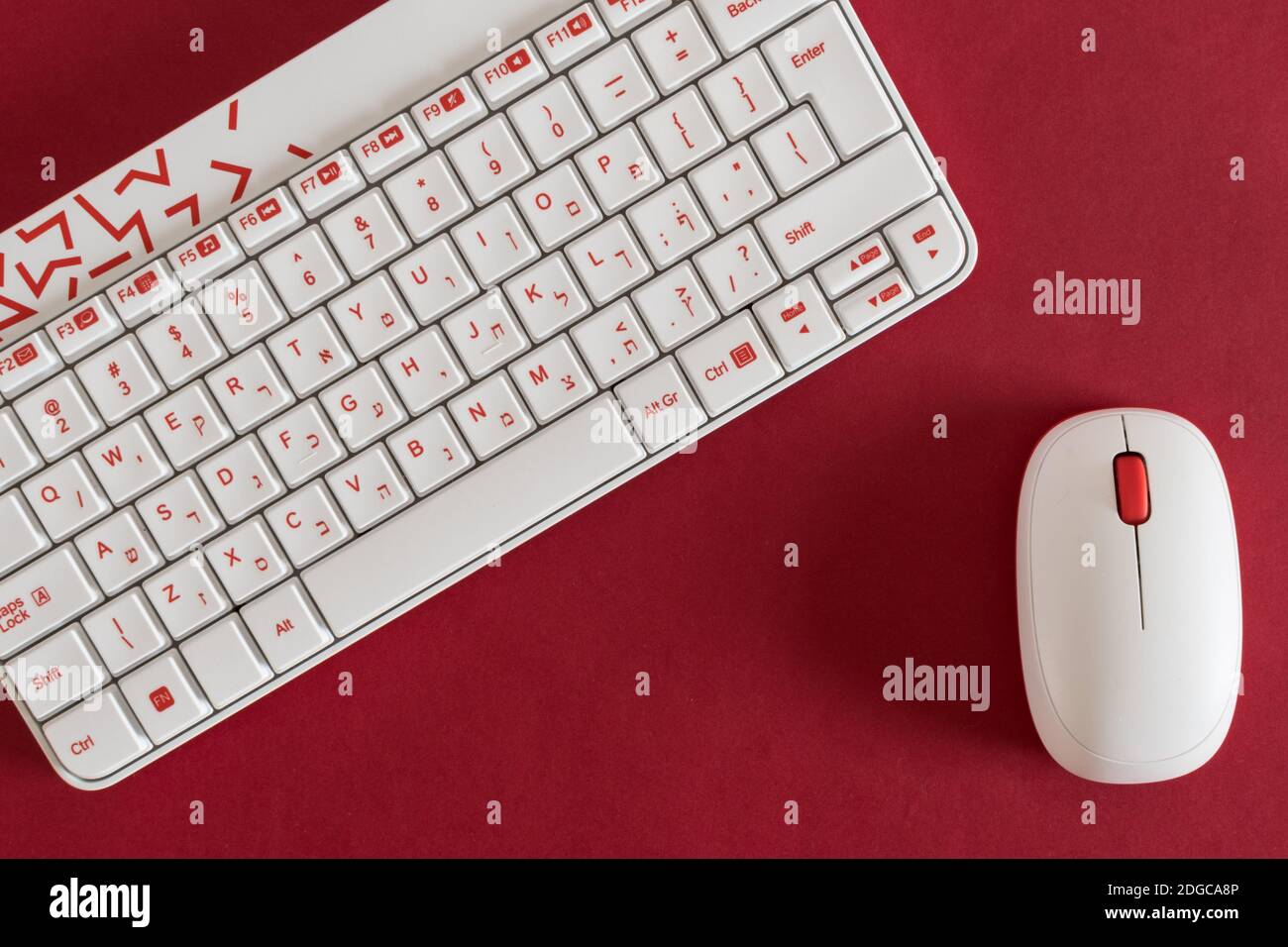 A flat lay of a modern white keyboard with a wireless mouse and on a ...