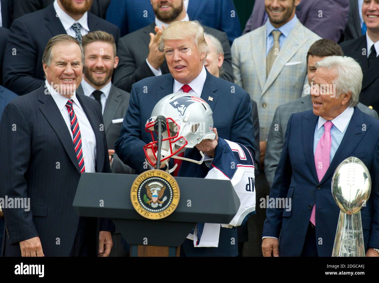 United States President Donald J. Trump, center, hold up the helmet he ...