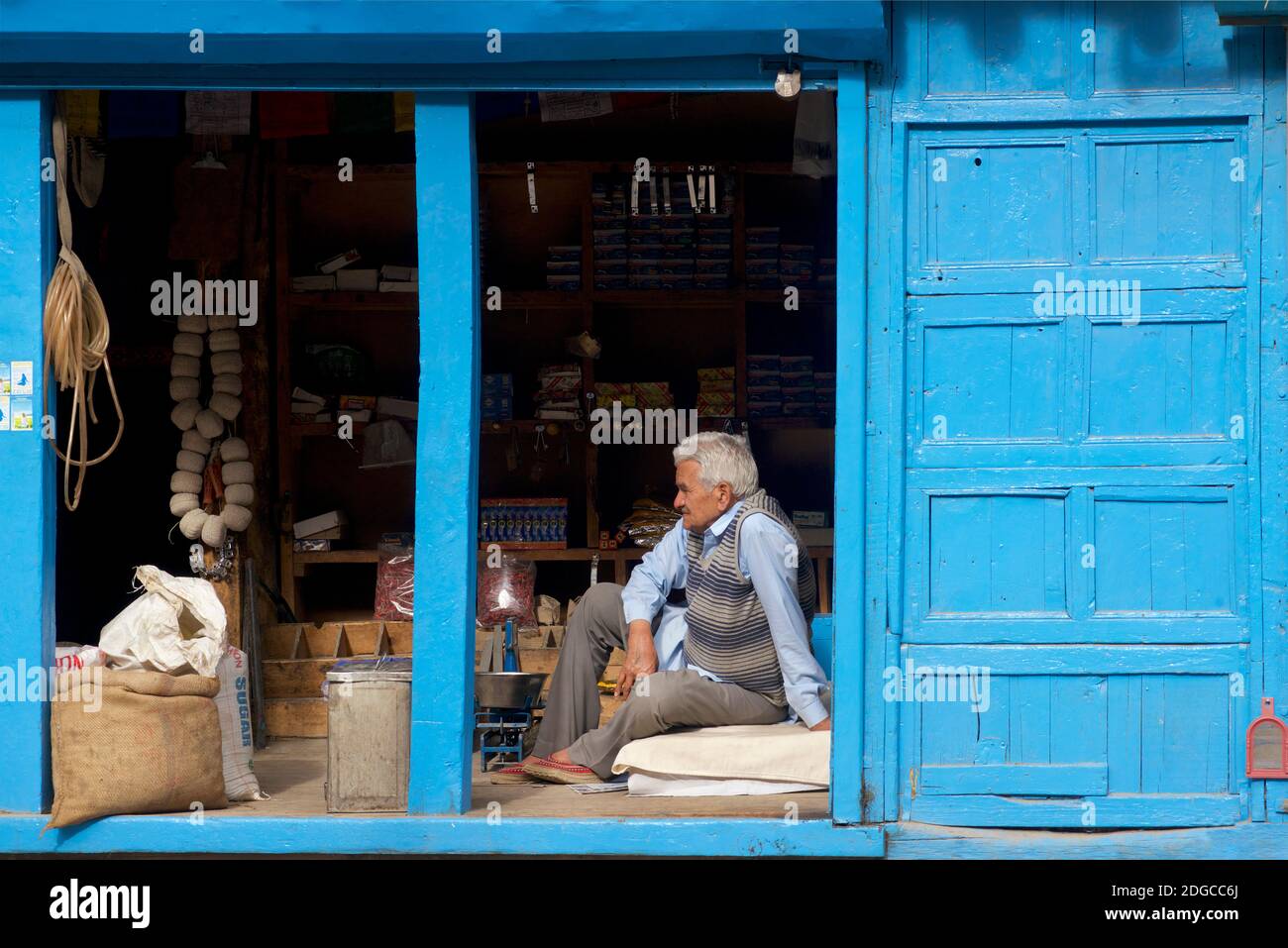 Local shopkeeper sitting in his shop. Leh, Ladakh, Jammu and Kashmir ...