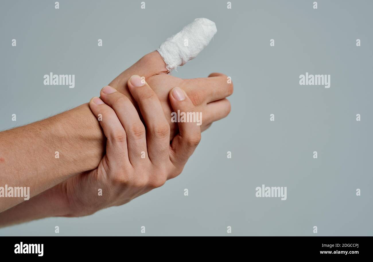 man in white t-shirt broken finger bandaged medicine Stock Photo - Alamy