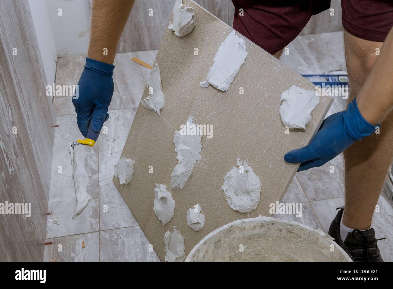 Tiler and plaster repair work laying tile, trowel in a man hand Stock ...