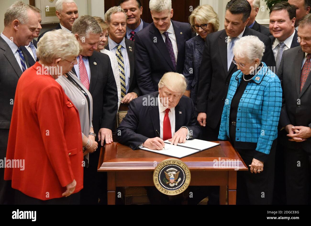 US President Donald Trump flanked by governors signs the Education ...