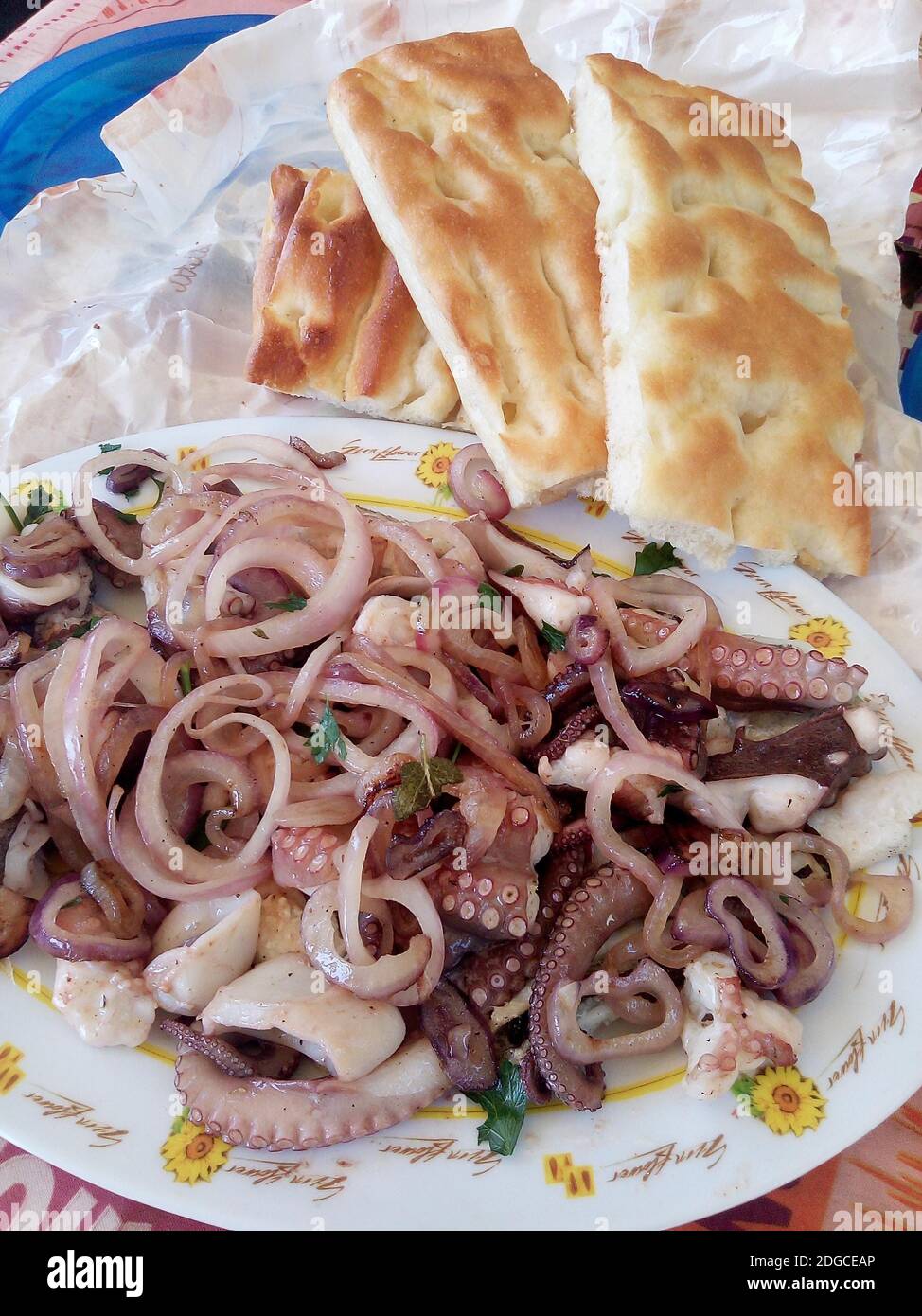 Italian cuisine: steamed octopus with red onions and Ligurian focaccia ...