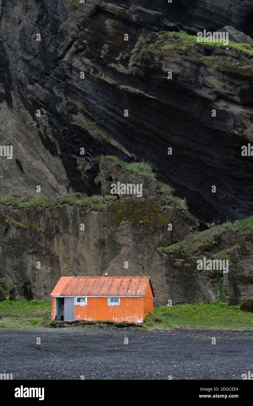 Hut in front of rock face Stock Photo - Alamy