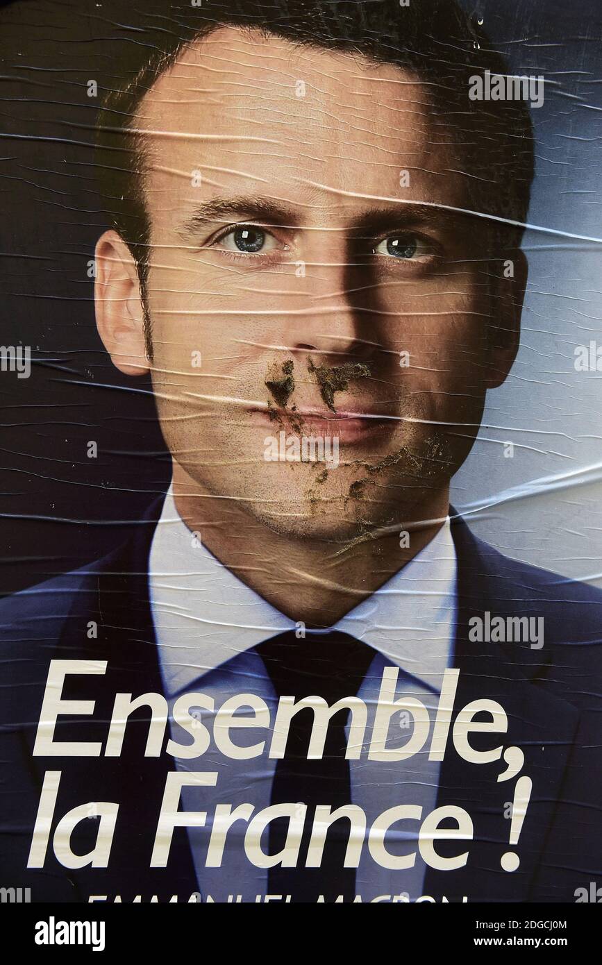 A presidential campaign poster shows centrist candidate Emmanuel Macron ...