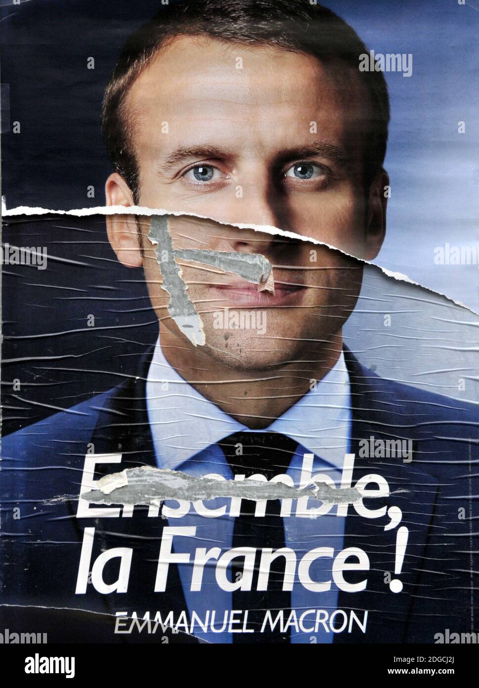 A presidential campaign poster shows centrist candidate Emmanuel Macron ...