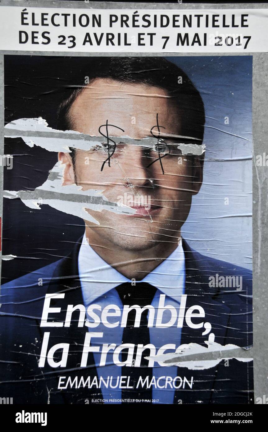 A presidential campaign poster shows centrist candidate Emmanuel Macron ...