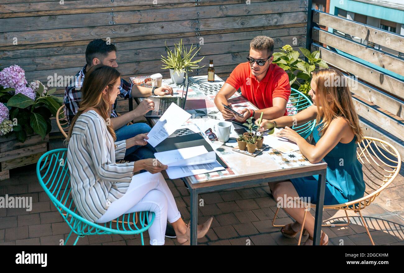 Group of people in a informal meeting on the terrace of the office ...