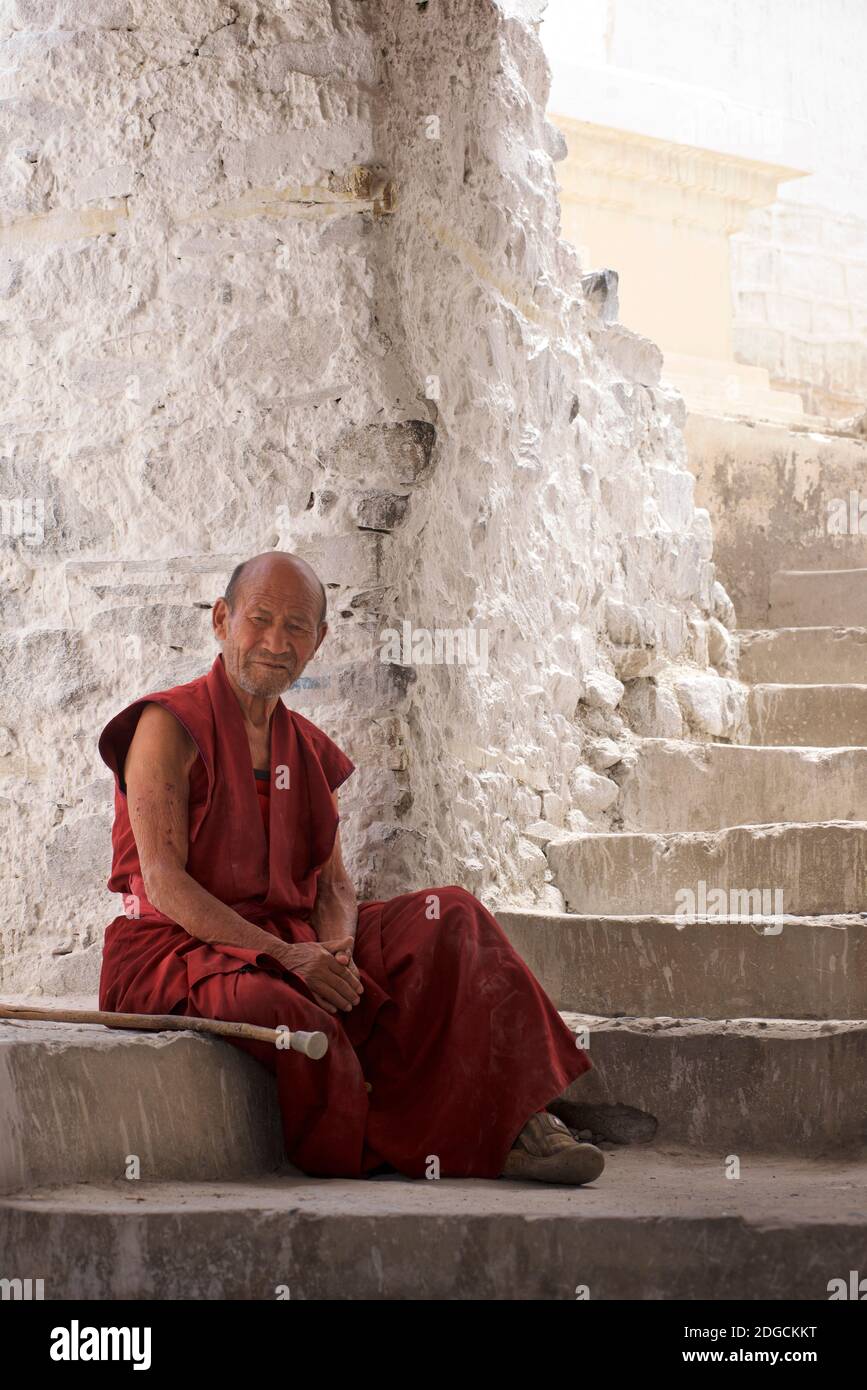 Portrait of a monk sitting on steps at Diskit monastery, also known as ...