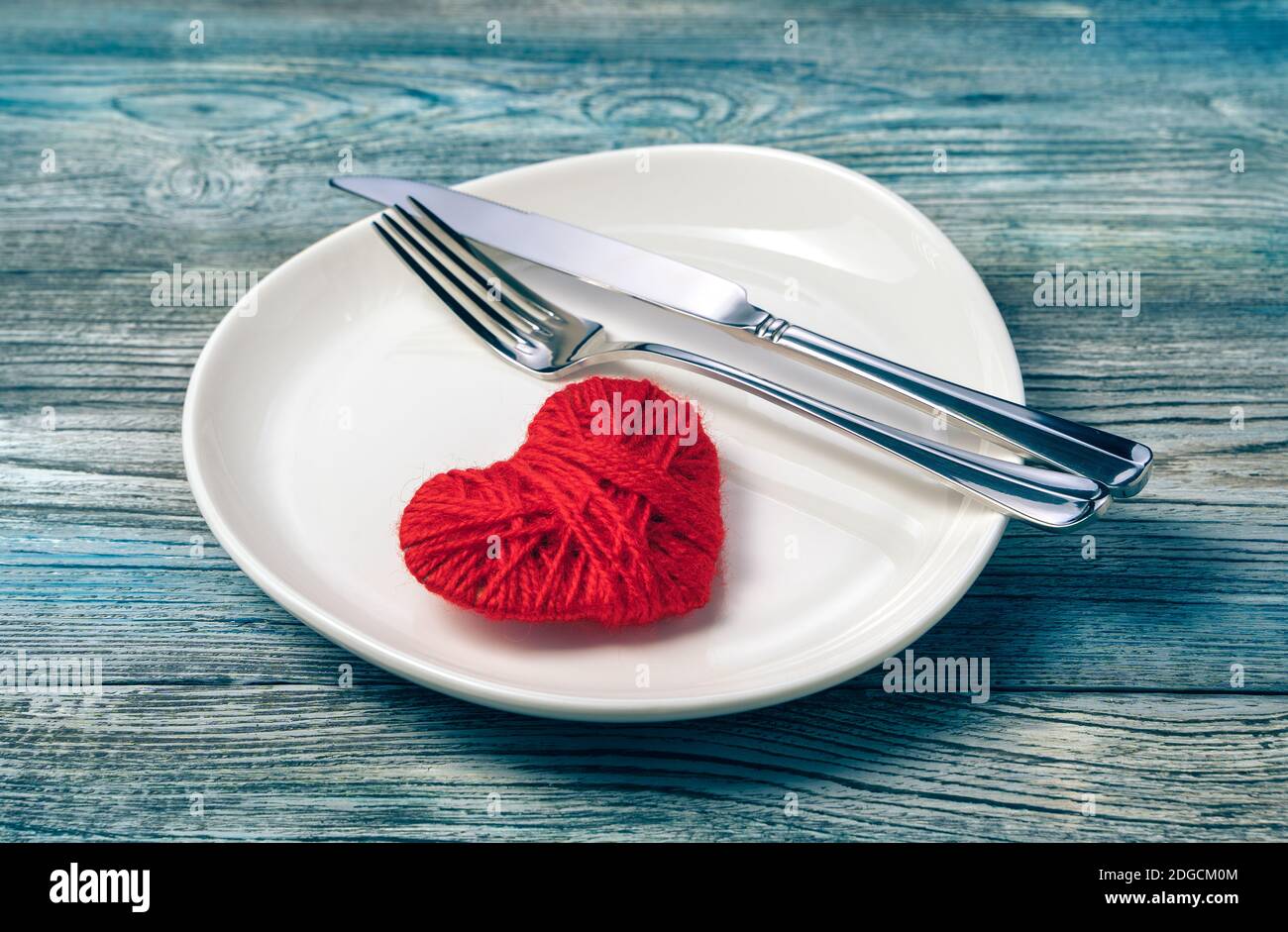 Romantic background with heart, plate and Cutlery on wooden background ...