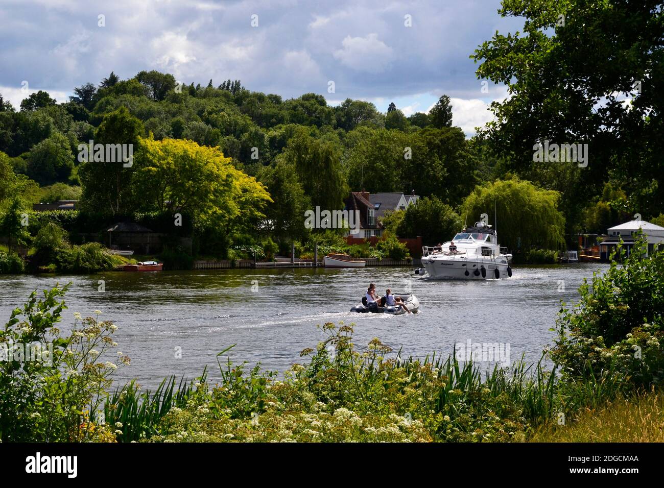 Family on a small motorboat, cruising along the River Thames, as a ...