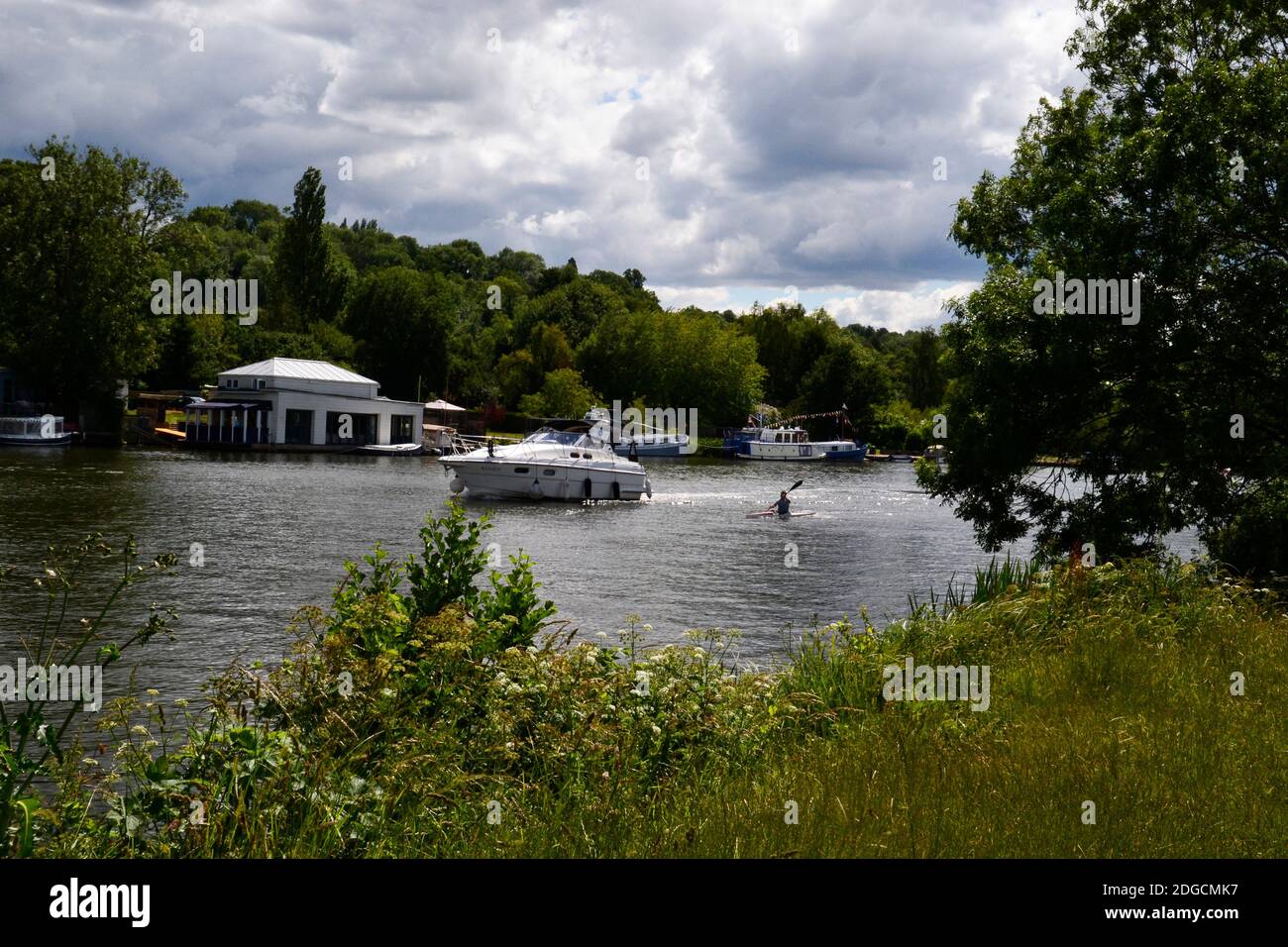 Canoeist and luxury yacht on the River Thames, Bourne End ...