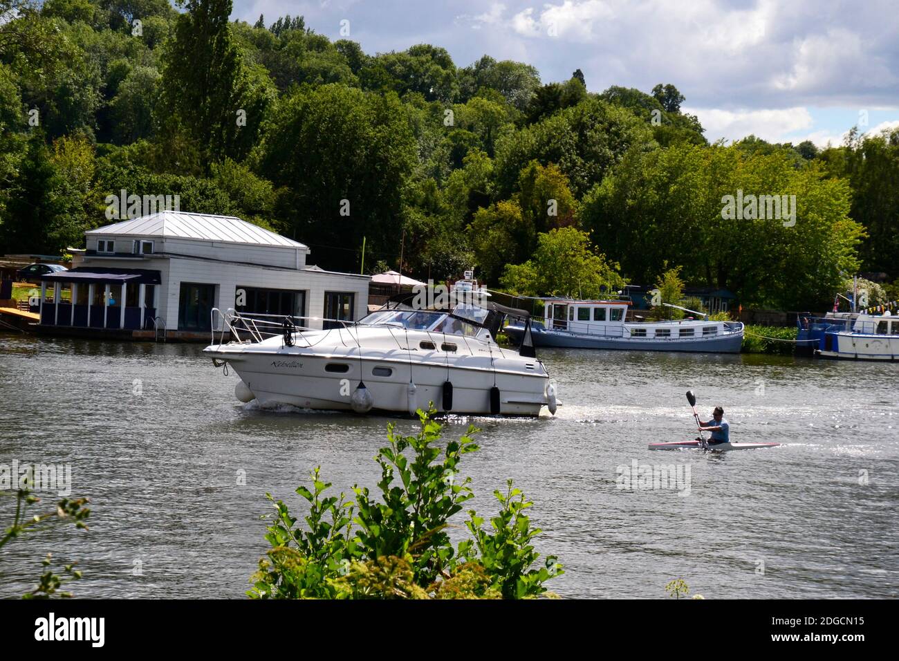 Canoeist and luxury yacht on the River Thames, Bourne End ...