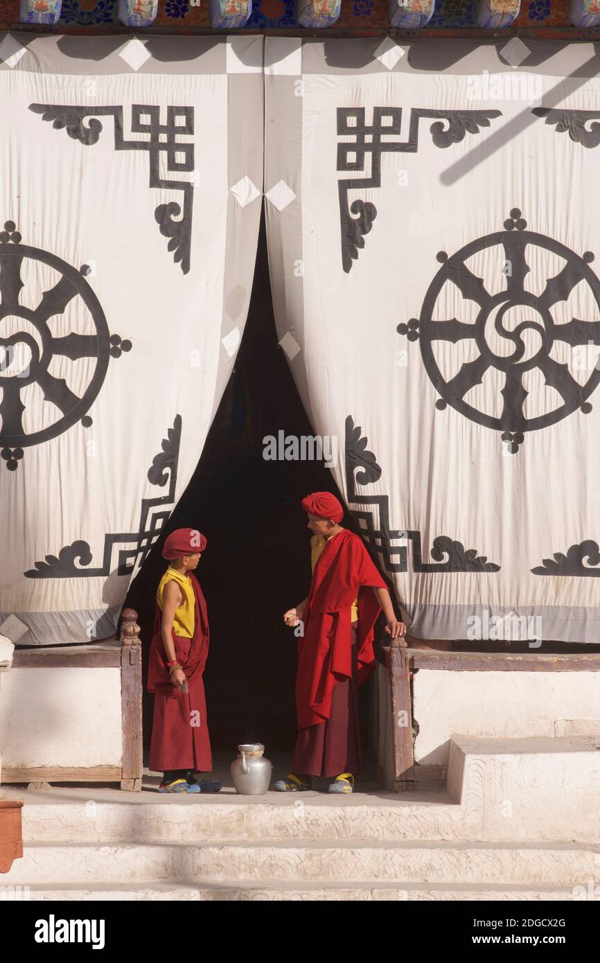 Early morning at Hemis monastery. Two young monks at the entrance to ...