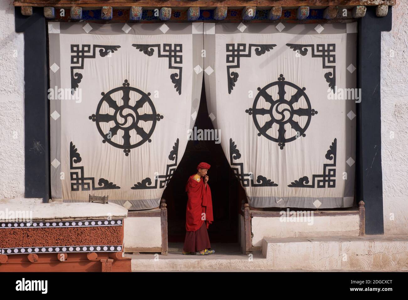 Early morning at Hemis monastery. A young monk at the entrance to the ...