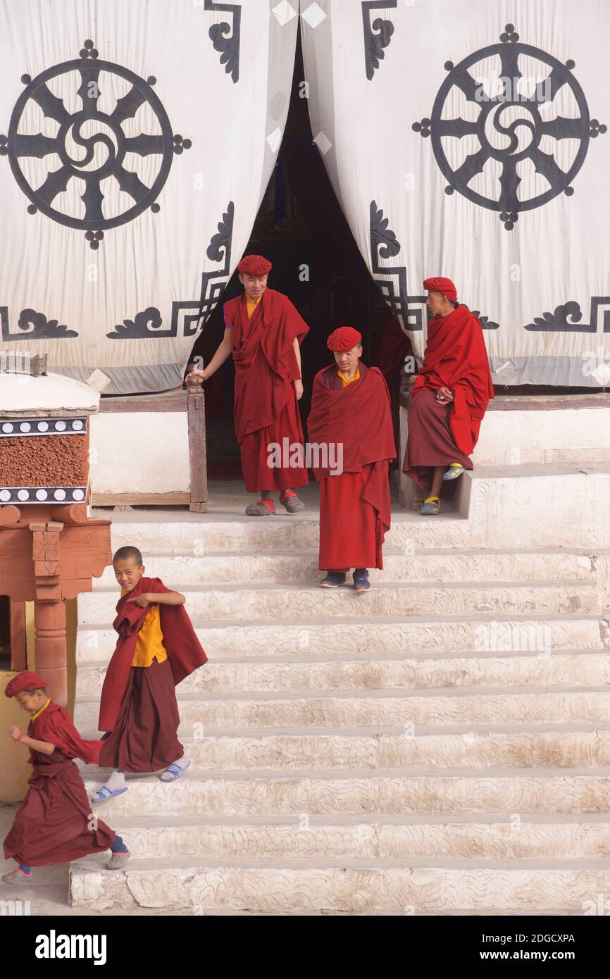 Early morning at Hemis monastery. Monks outside leaving the prayer hall ...