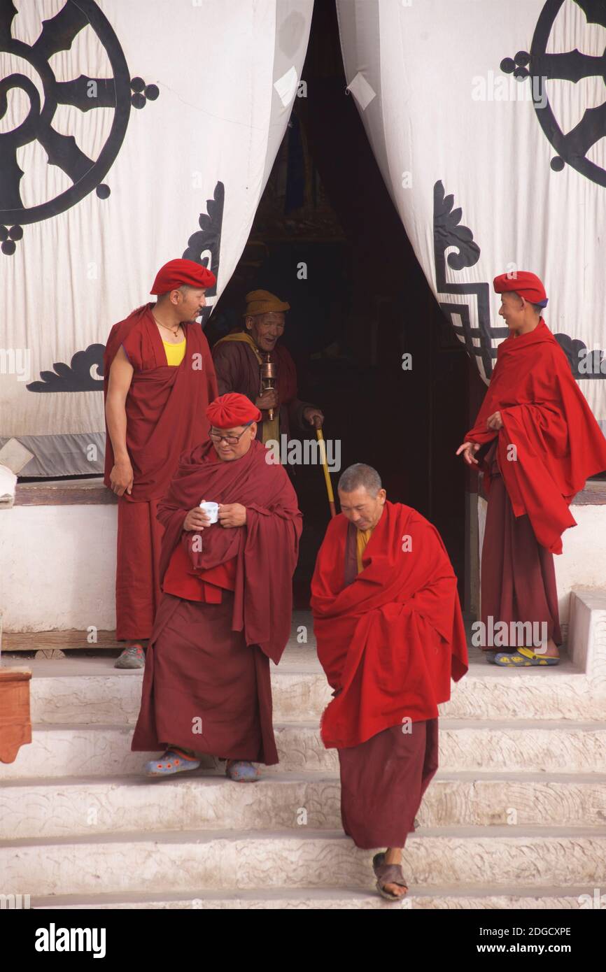 Early morning at Hemis monastery. Monks outside leaving the prayer hall ...