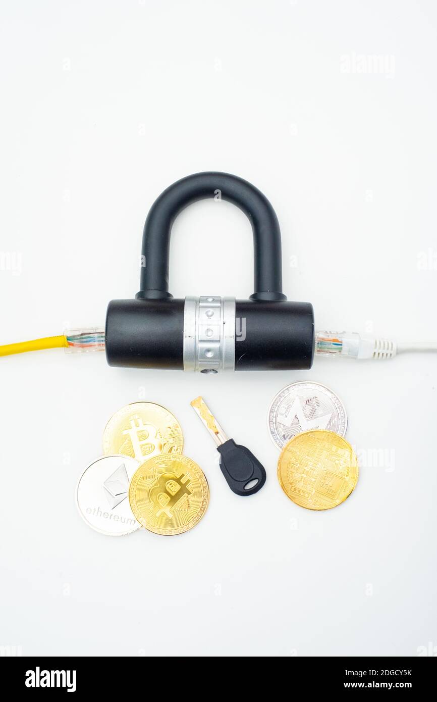 Two computer network cables going through a lock with a key and a ...