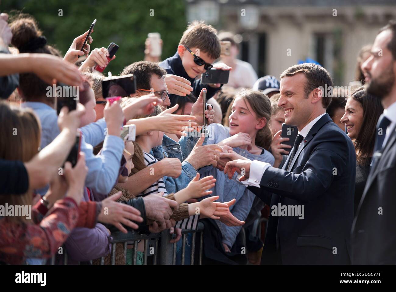 French President Emmanuel Macron greets people in the crowd as he ...