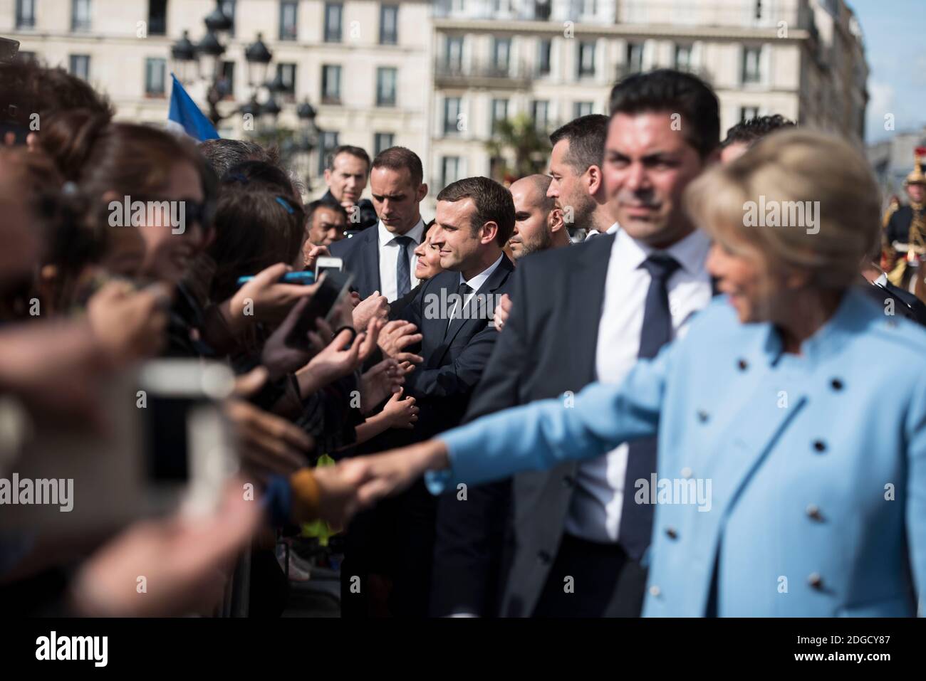 French President Emmanuel Macron greets people in the crowd as he ...