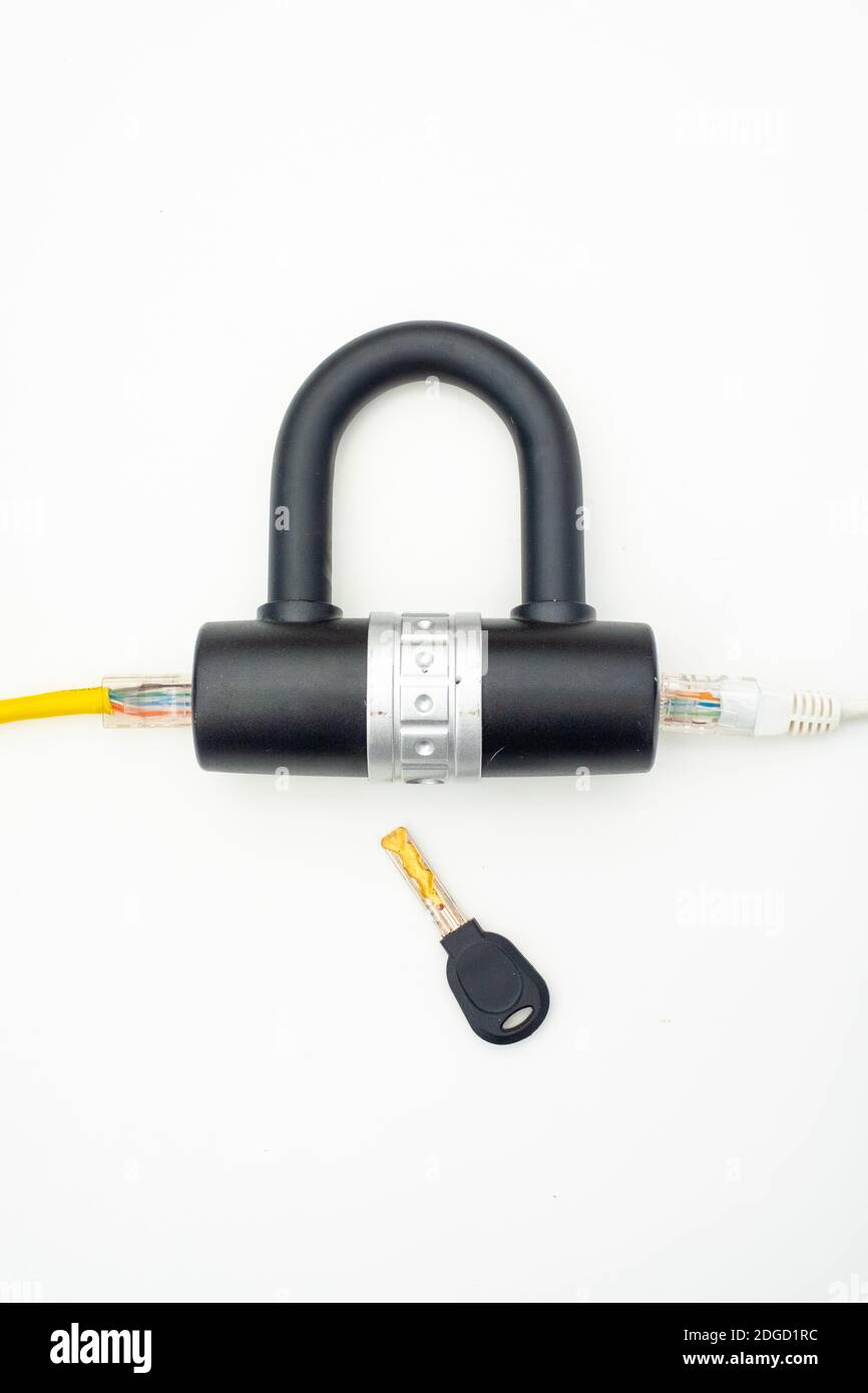 Two computer network cables going through a lock with a key Stock Photo ...
