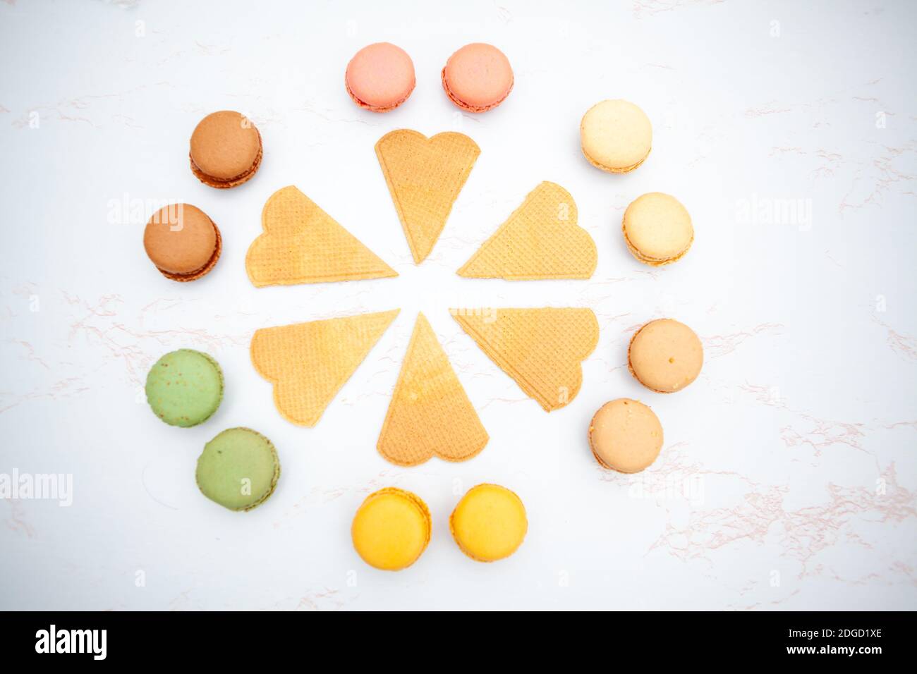 Fun flat lay composition of macarons and a cookie Stock Photo - Alamy