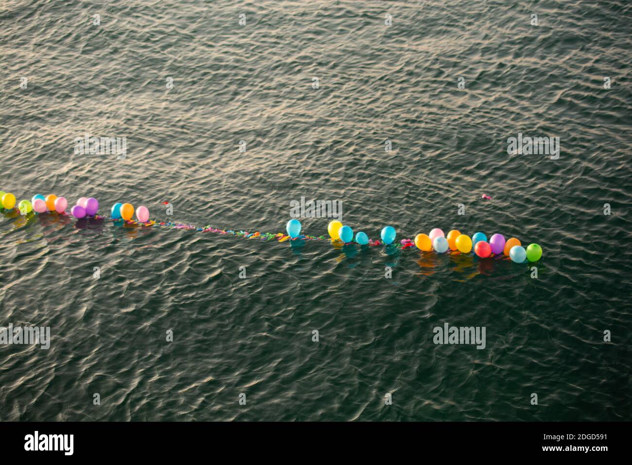 Balloon on a string on water for shooting game Stock Photo - Alamy