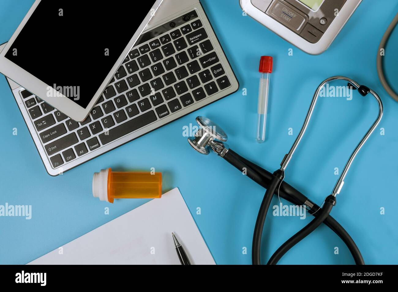 Modern electric tonometer and a stethoscope on a computer keyboard ...