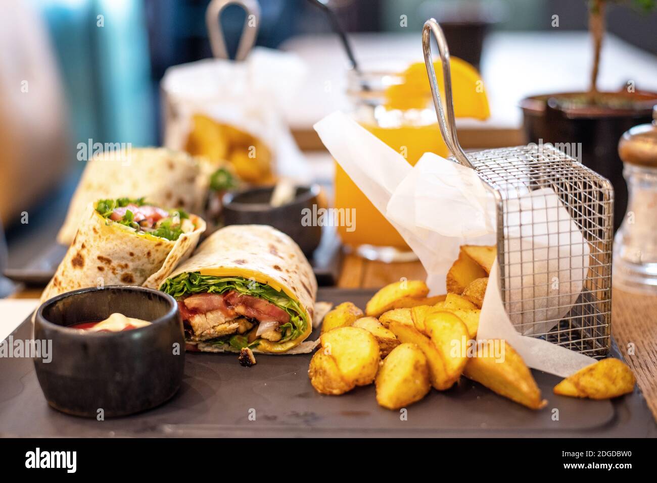 Beef shawarma wrap with vegetables. roasted potatoes and cream sauce on ...