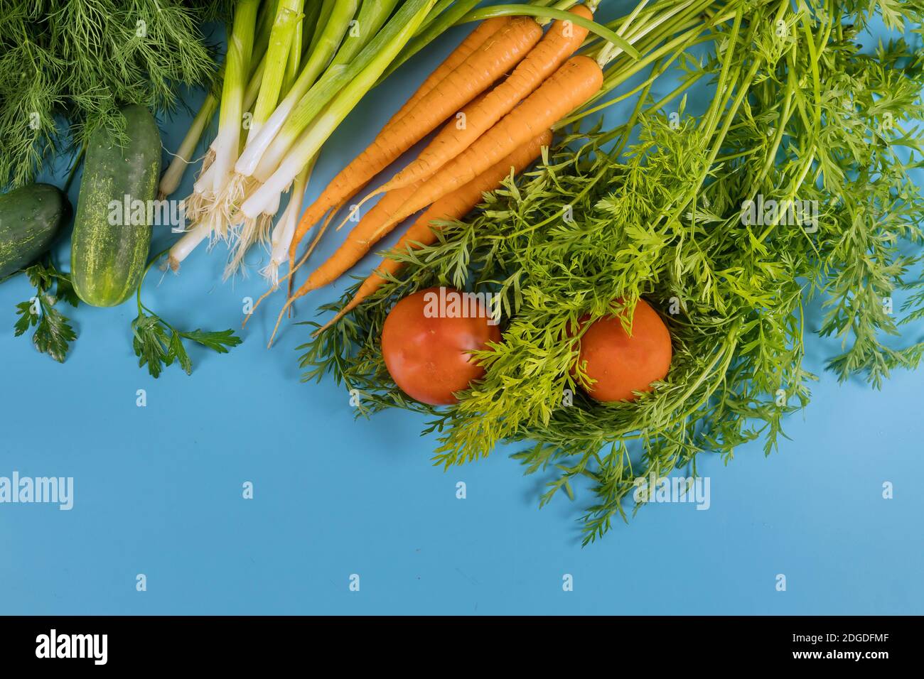 Fresh organic vegetables on blue background Stock Photo - Alamy