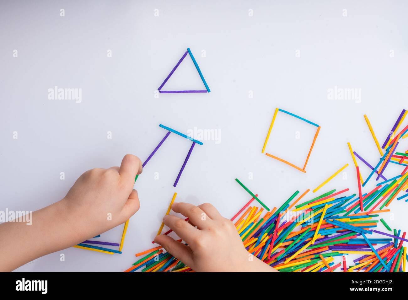 Kid making rectangular and triangle shape as creative concept Stock ...