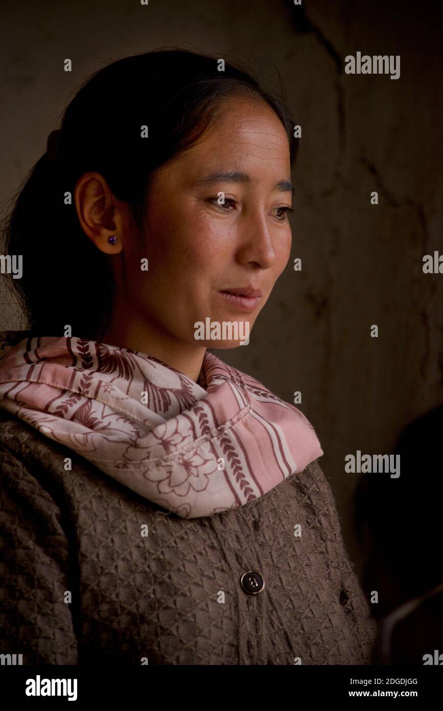 Portrait of a young Ladakhi woman in contemporary Ladakhi attire ...