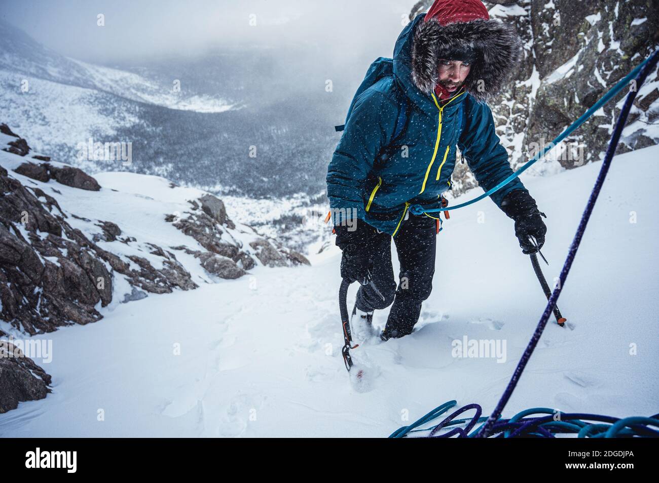 Alpine climber climbs up a steep section of snow Stock Photo - Alamy