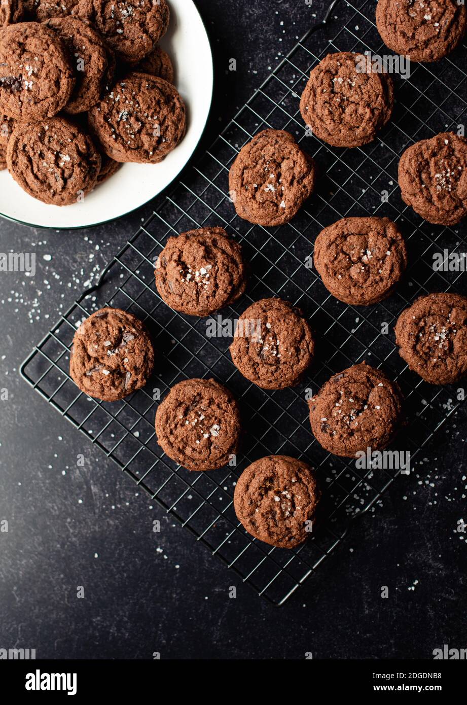 Overhead view of salted dark chocolate cookies on black counter Stock ...