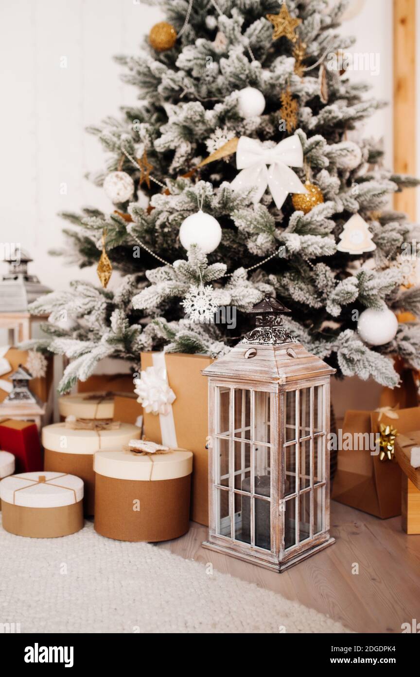 vertical image high lantern wooden candlestick under the Christmas tree ...