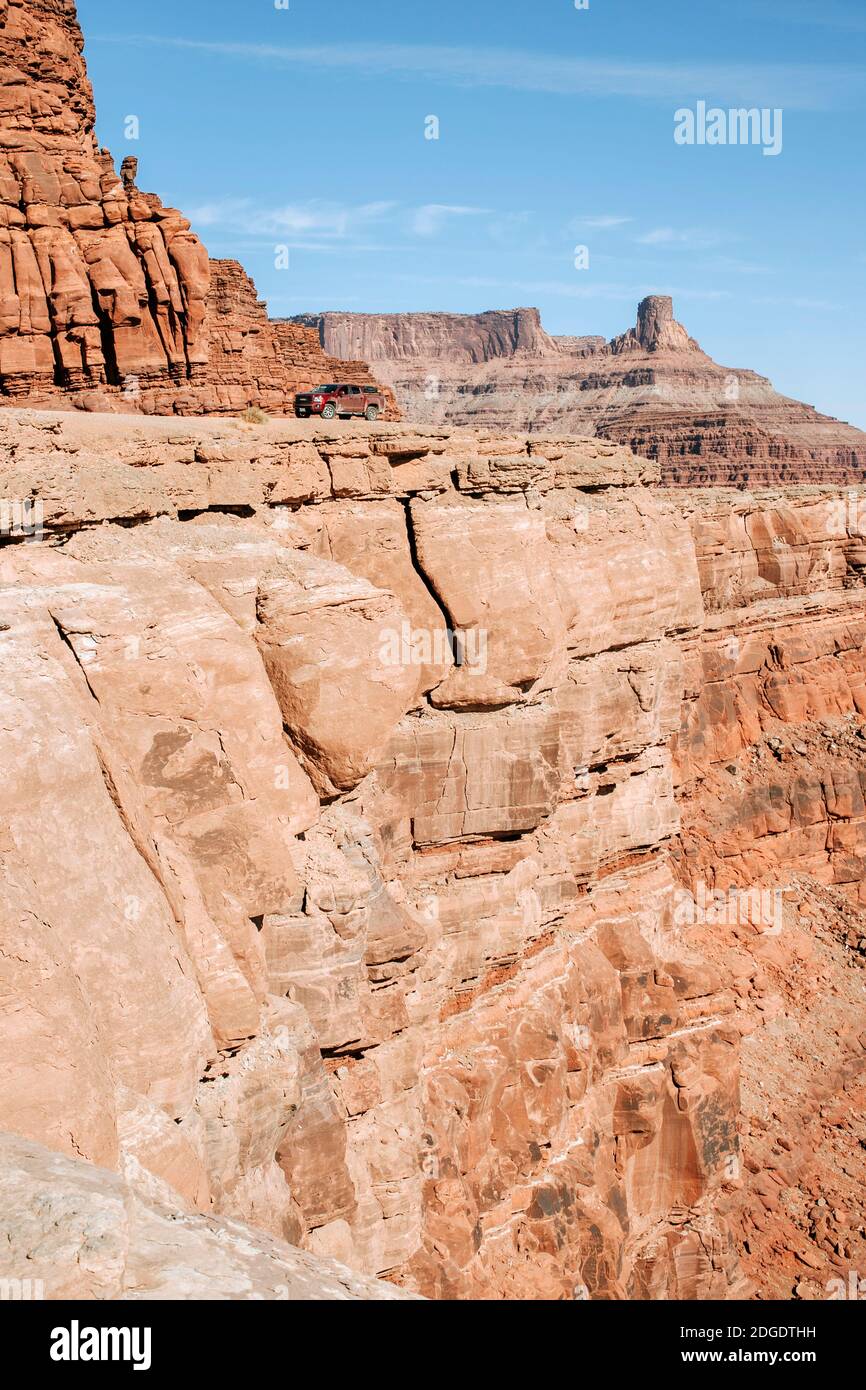red pick up truck on the edge of a cliff near Moab Utah Stock Photo - Alamy
