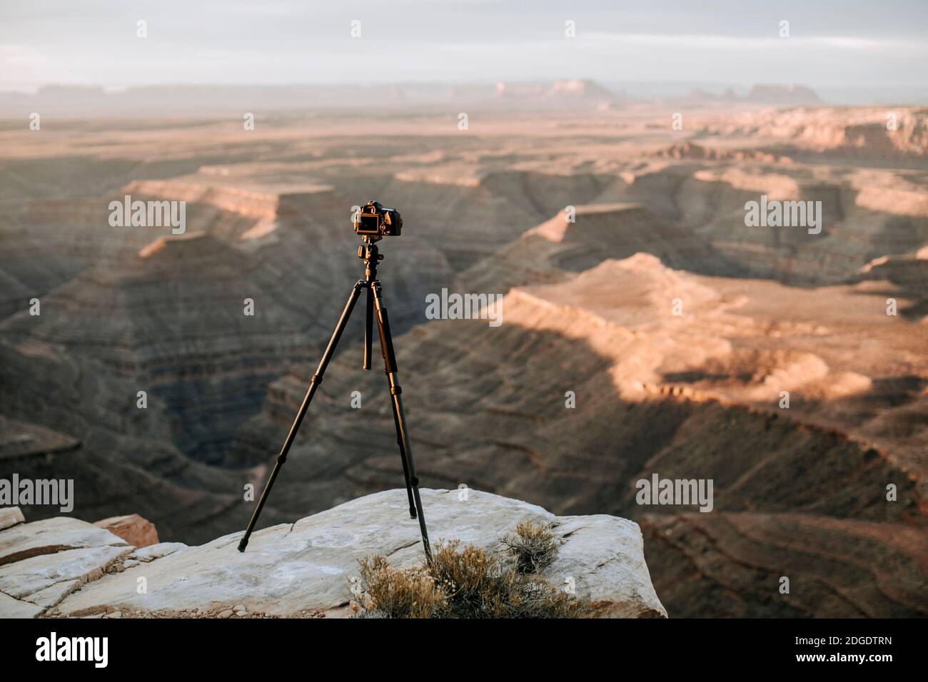 camera and tripod on cliff edge in front of scenic view, Utah desert ...