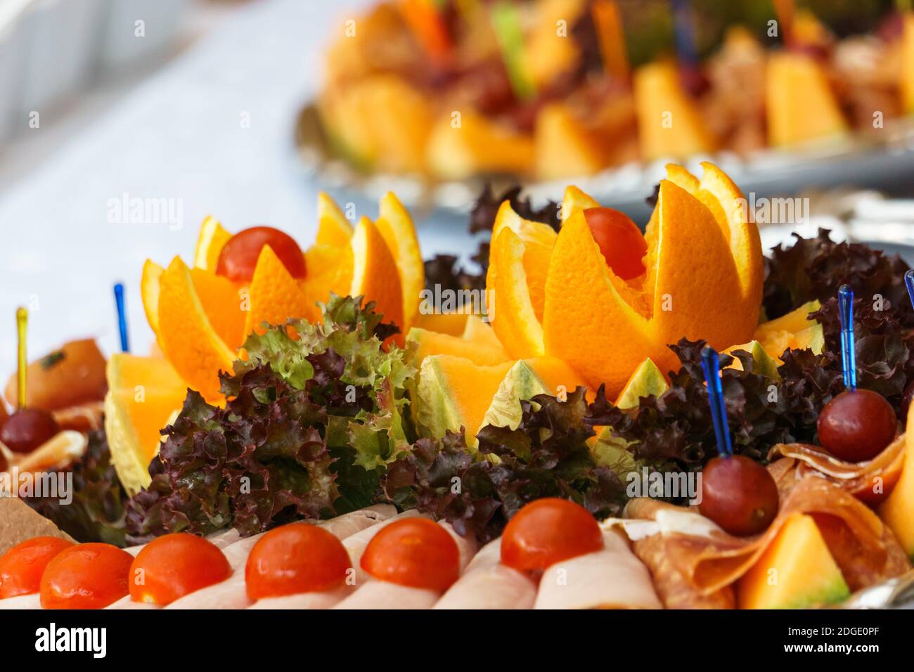 Summer buffet with orange, tomatoes, ham and asparagus Stock Photo - Alamy