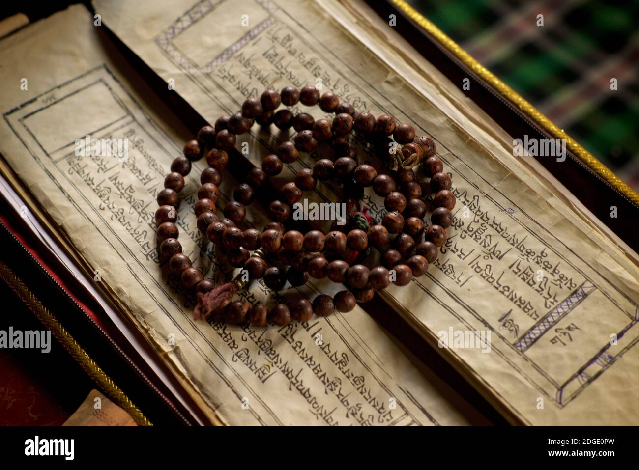 Prayer beads and buddhist folio manuscript. Mulbekh monastery, Kargil ...